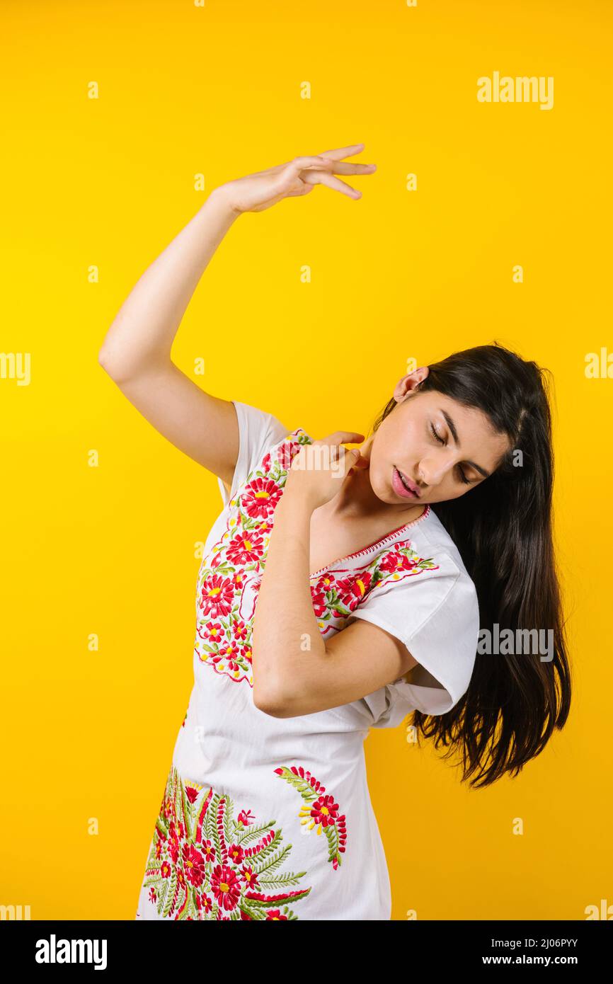 portrait of young hispanic woman with mexican traditional dress and ...