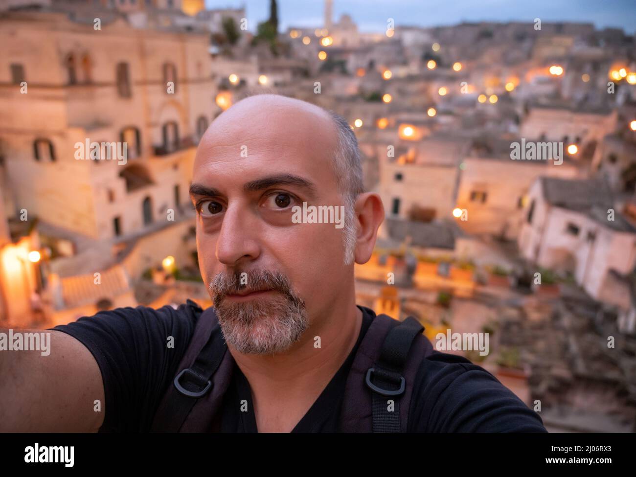 Matera, Basilicata, Italy. A middle-aged man takes a selfie with the ...