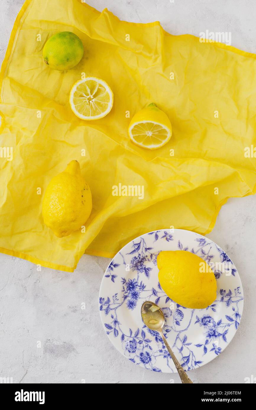 Aerial view of lemons and citrus fruits on a vibrant yellow and white ...