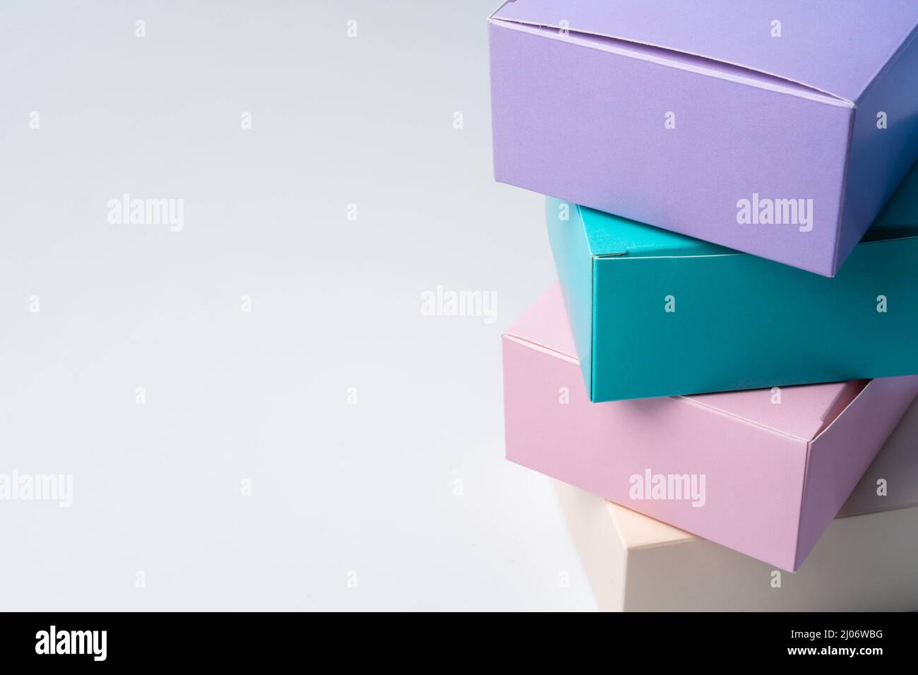 Pile of colorful cardboard boxes on white background Stock Photo - Alamy