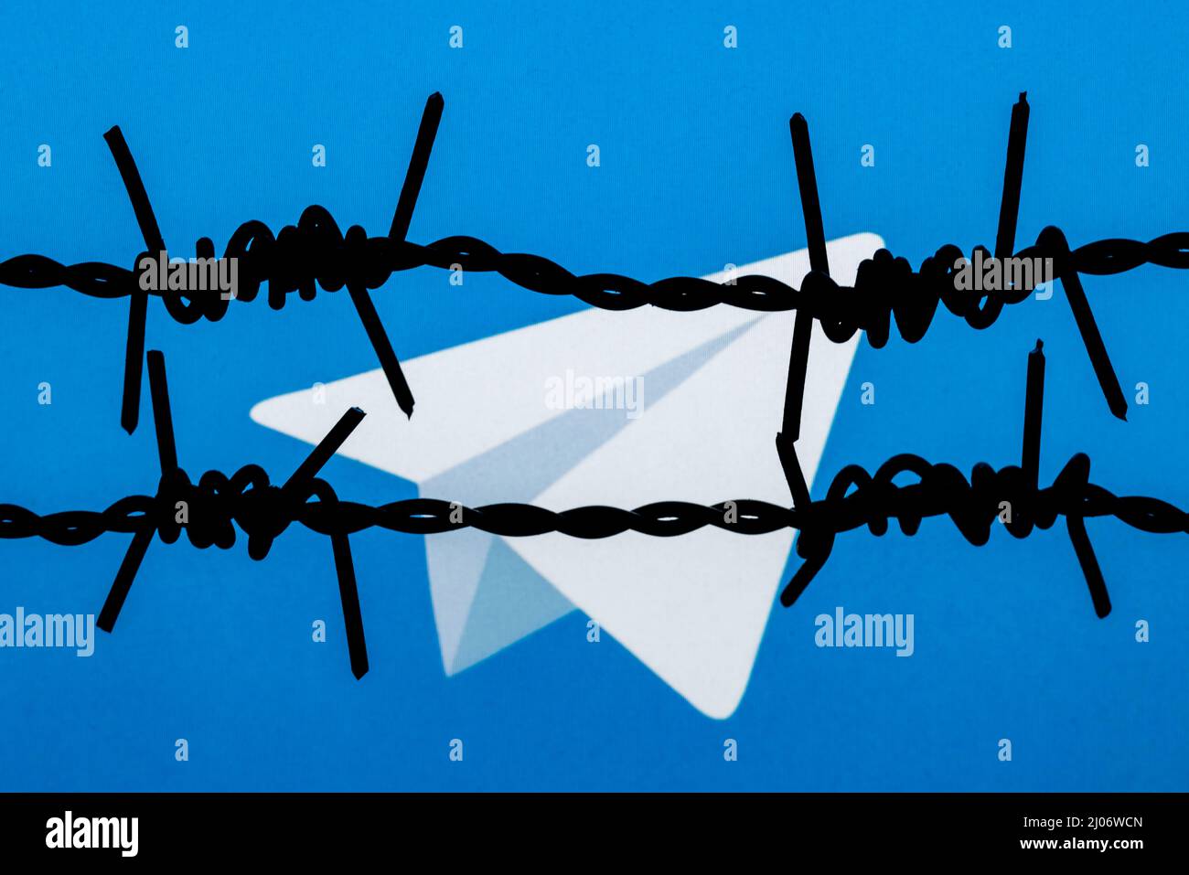 Telegram messenger logo behind barbed wire. The concept of Telegram ...