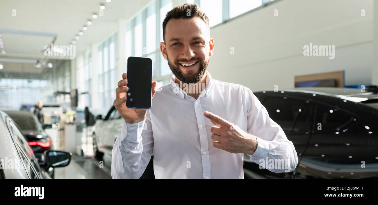 charismatic friendly shawarma manager of a car dealership demonstrates ...