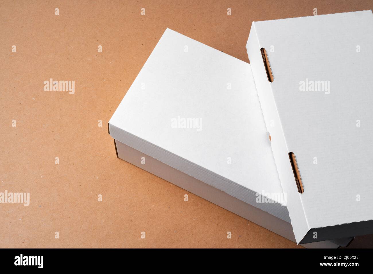 Cardboard box on beige background in studio Stock Photo - Alamy