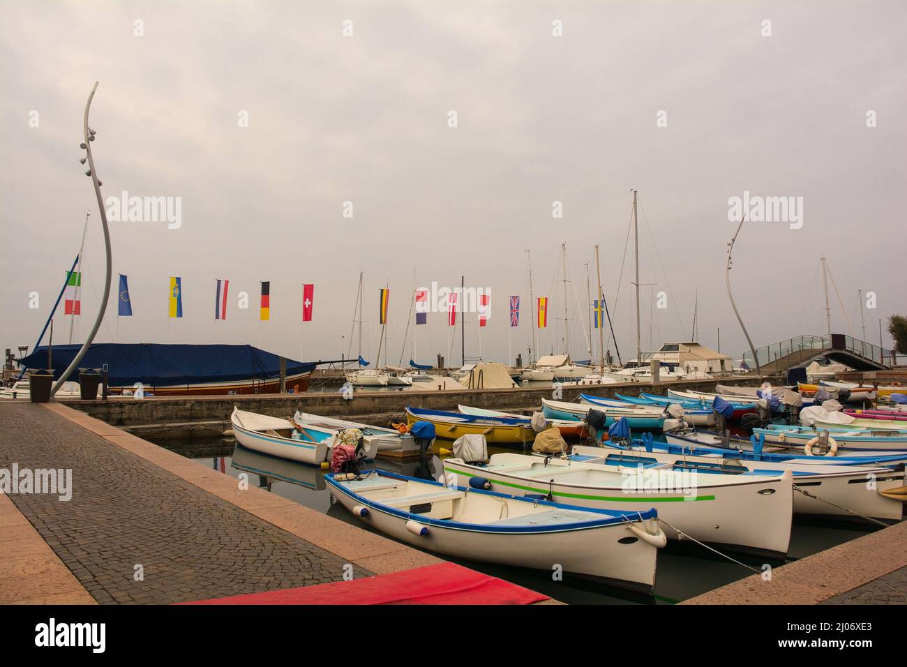 A pier and boats on the waterfront of Bardolino on the east shore of ...