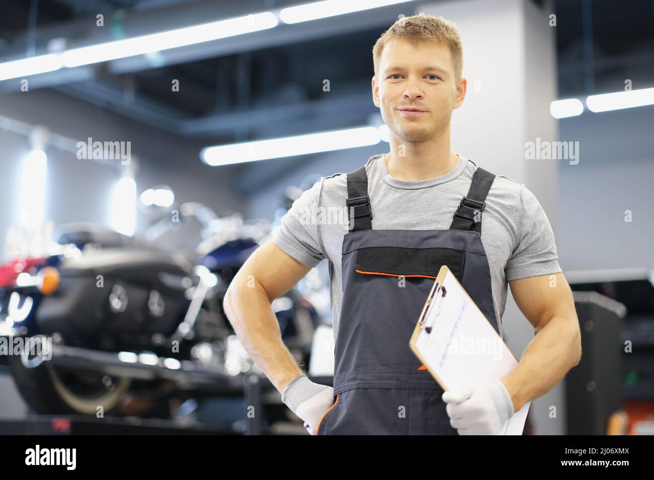 Qualified maintenance service worker in uniform, man with clipboard ...