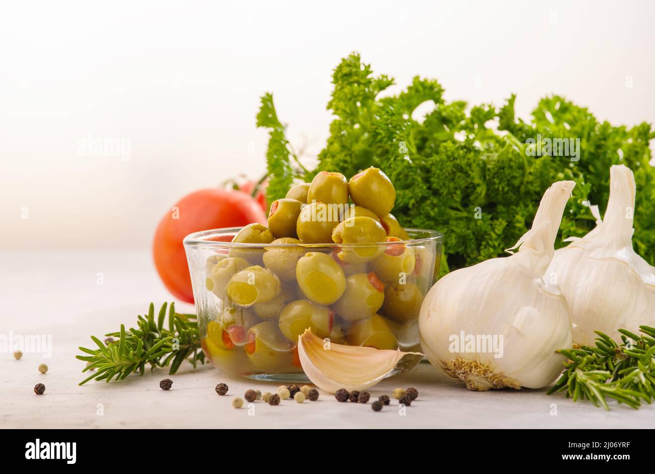 A beautiful still life - black pepper grains are scattered on a white ...