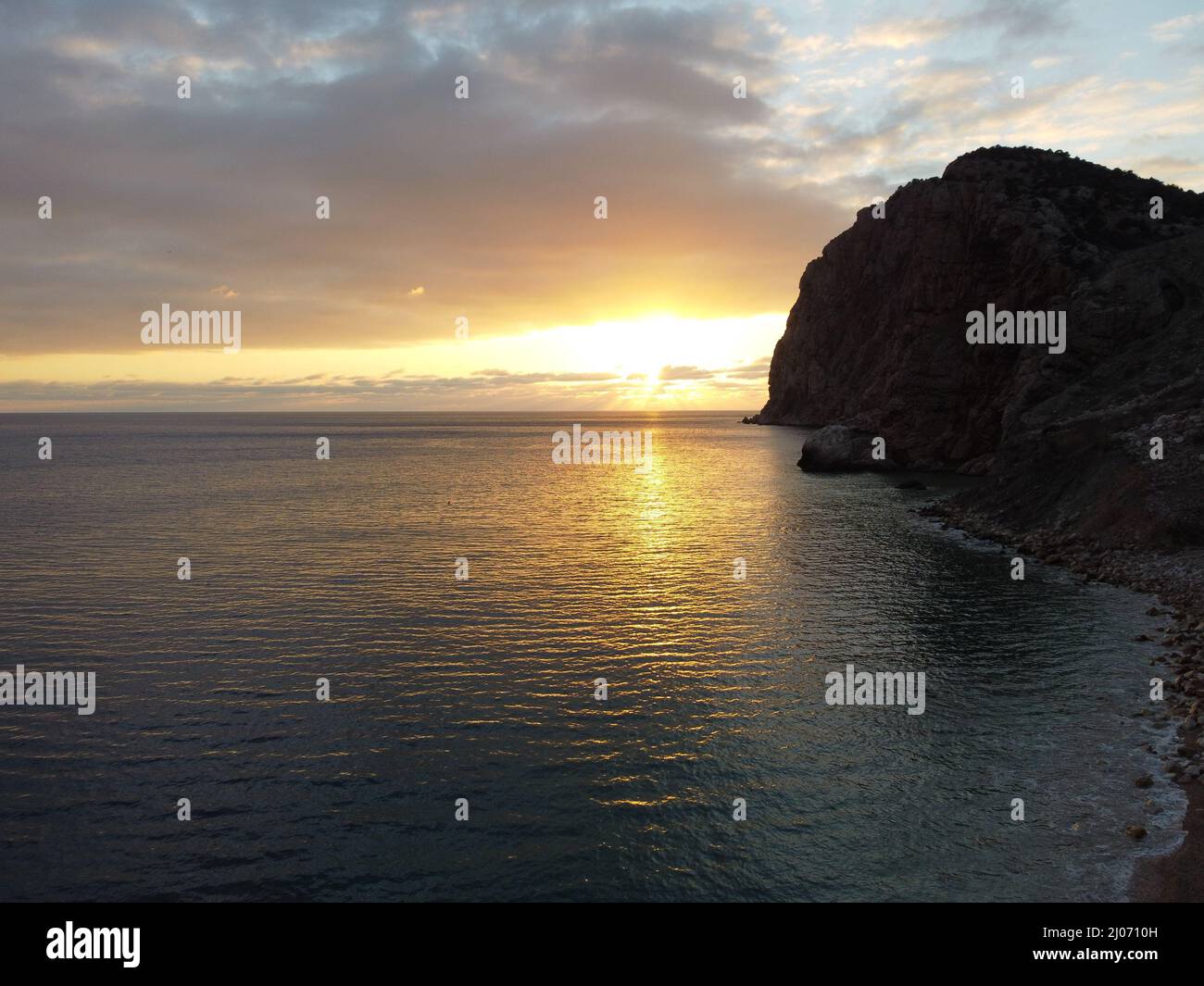 Aerial panoramic view of beautiful sunset above calm azure sea and ...