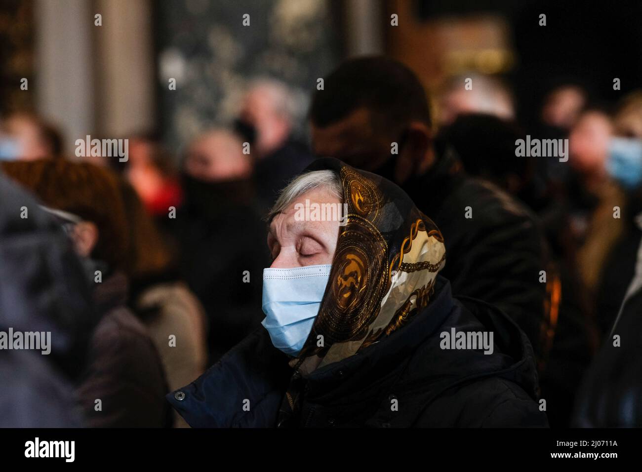 Lviv, Ukraine. 13th Mar, 2021. A churchgoer prays while closing her ...