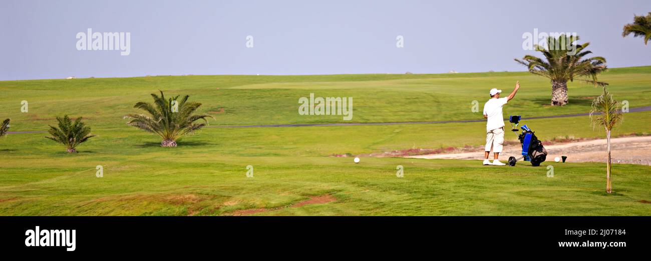 Man is checking the wind direction at exotic golf course Stock Photo ...