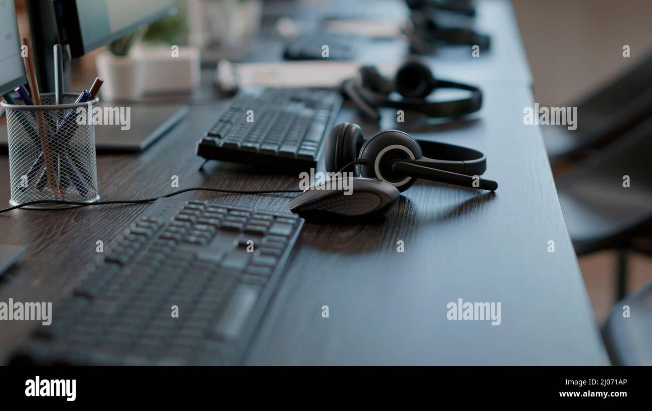 Call center desk with audio headsets and computers, technology used for ...