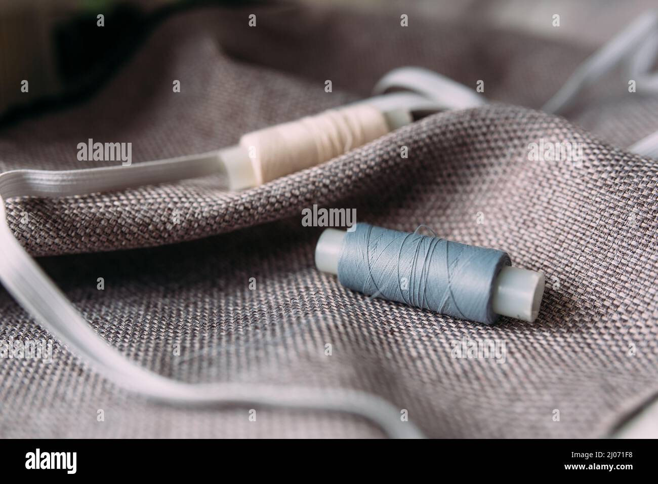 Fabric and thread. The concept of sewing and fashion design Stock Photo ...