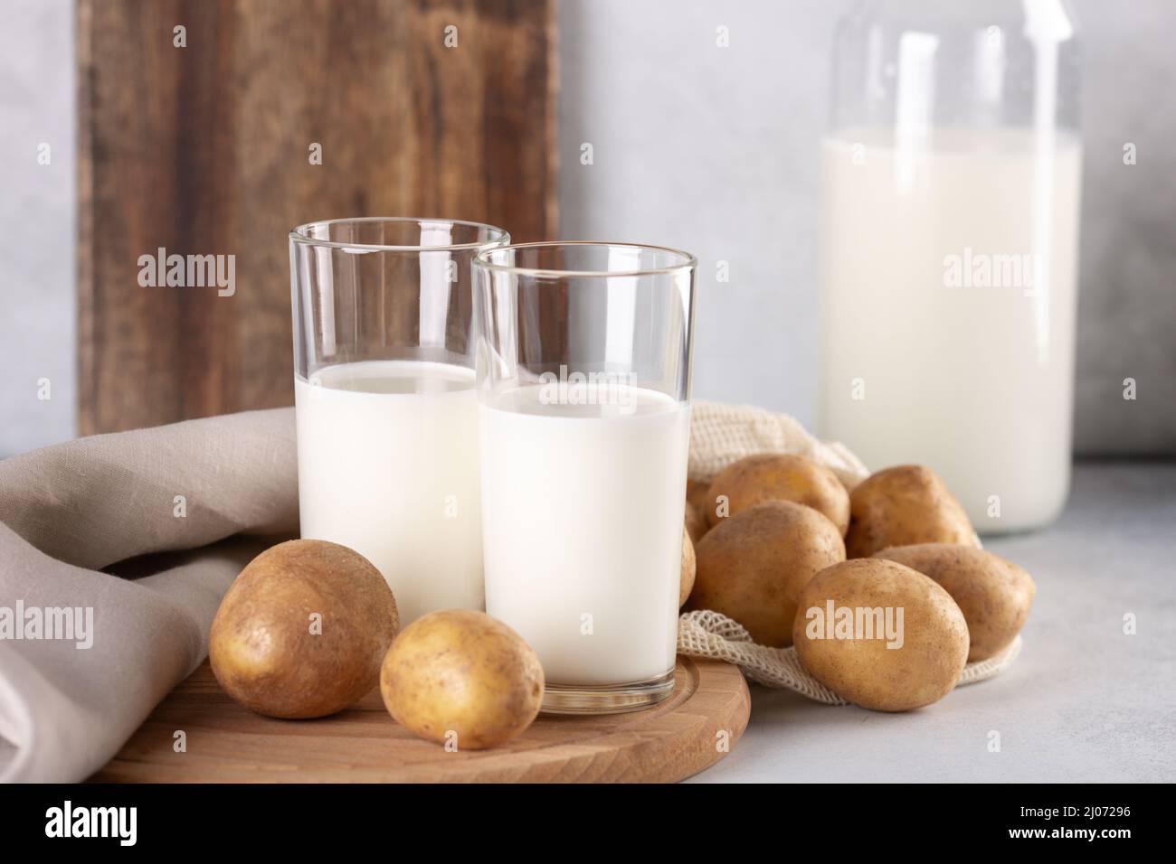 Vegan plant based milk in two transparent glasses and bottle ...