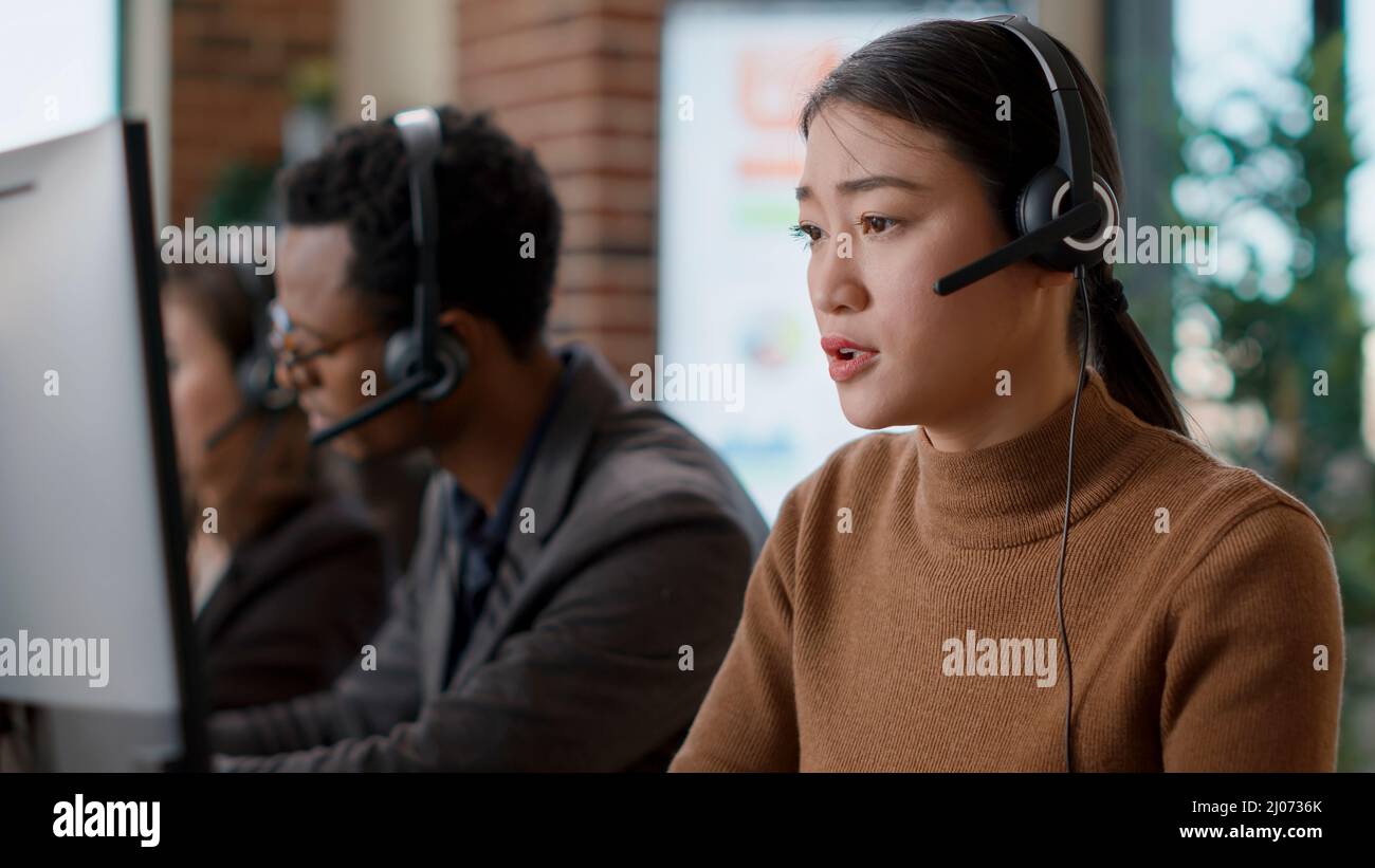 Telemarketing operator using headset to guide clients, helping with sales assistance and support ...