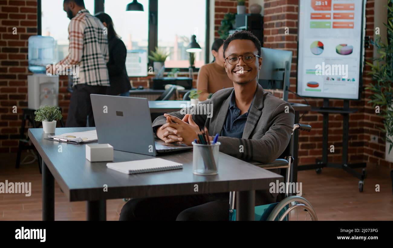 Portrait of person with disability smiling at camera at preparing to ...