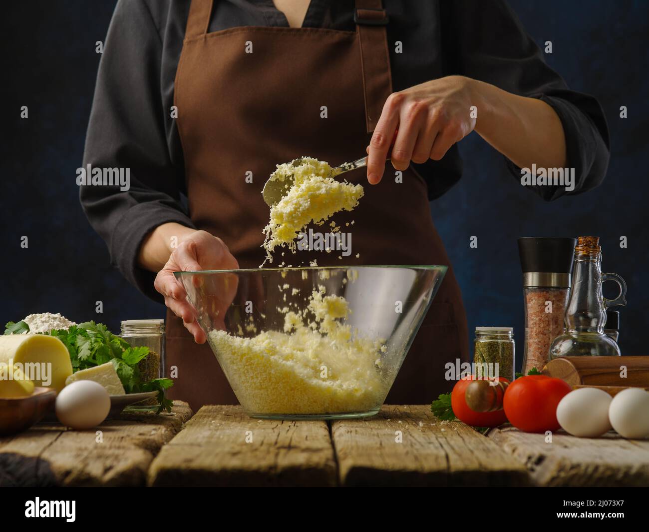 Chef rubs cheese mozzarella, for preparation of salad, pizza .Freezing ...