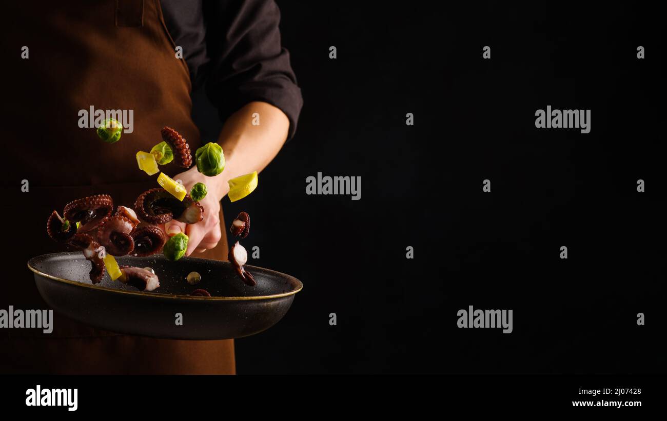 Chef roasts octopus pieces in frying pan. Concept of cooking seafood ...