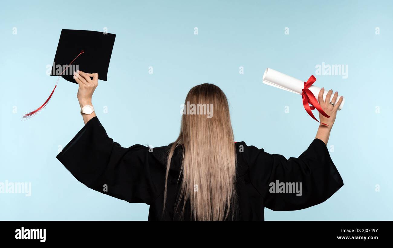 Girl graduate in graduation ceremony robe holding Diploma Certificate ...