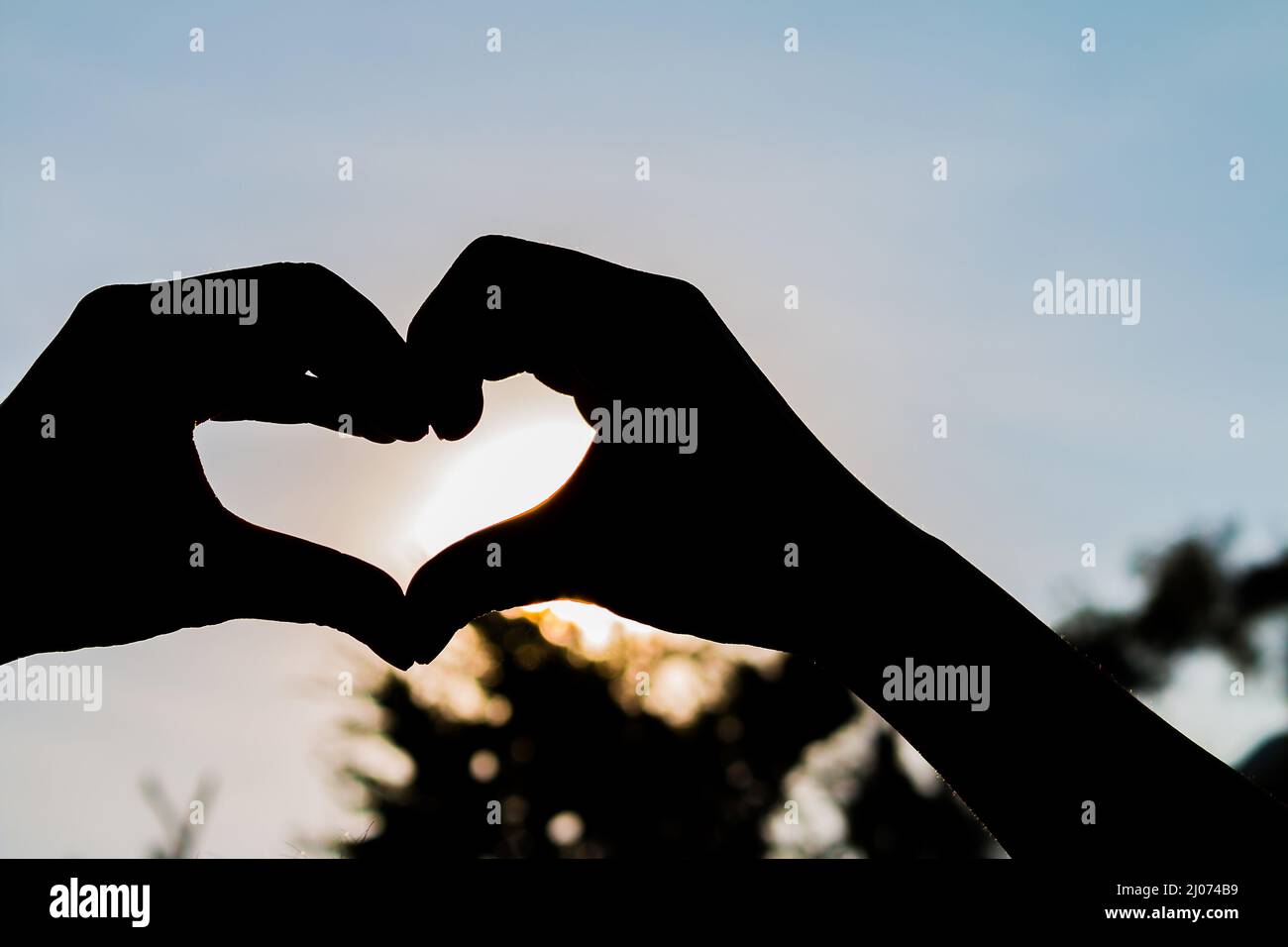 love shape hand silhouette at sunset background Stock Photo - Alamy