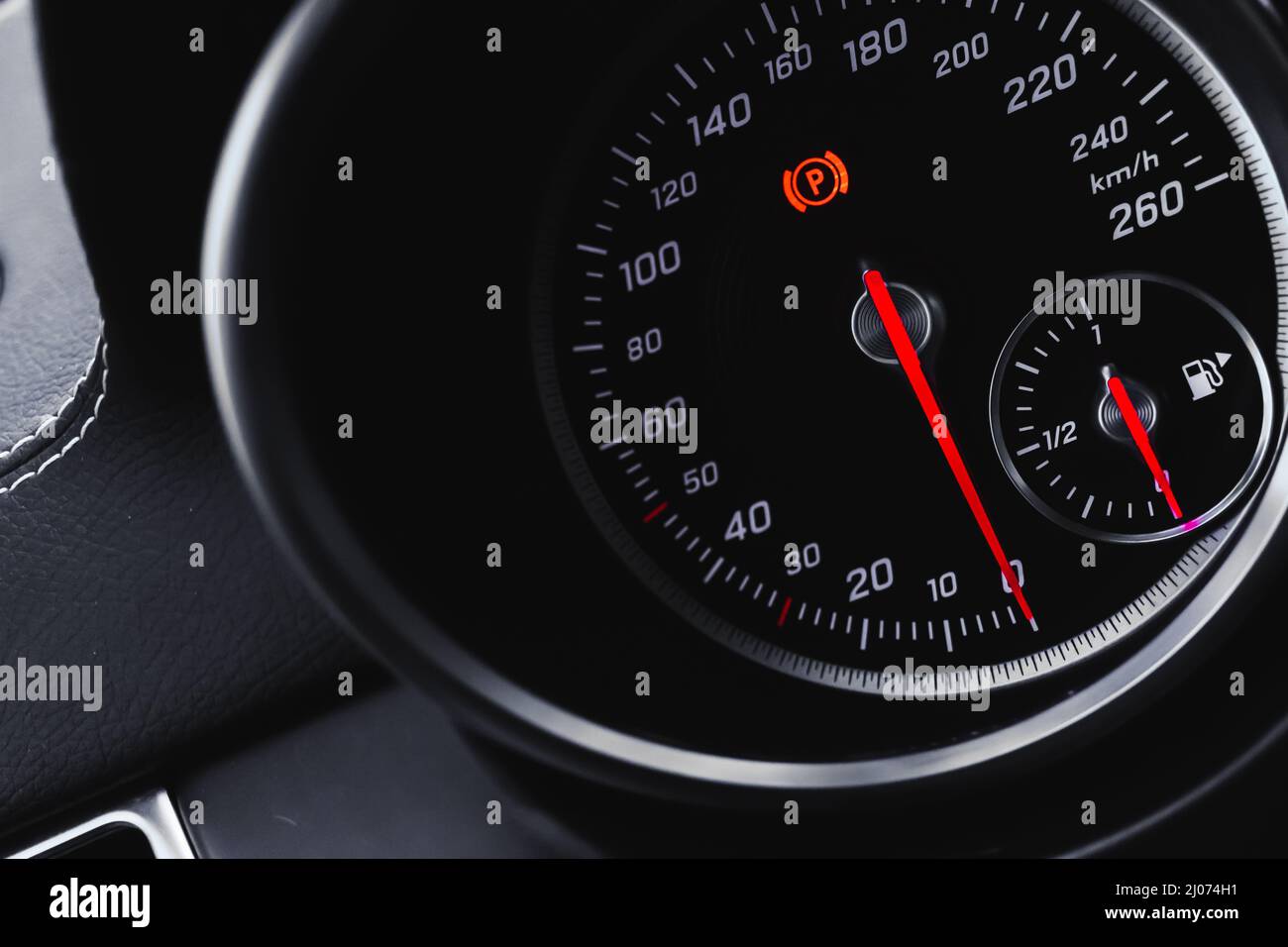 Car speedometer, luxury dashboard with glowing red indicators close-up ...
