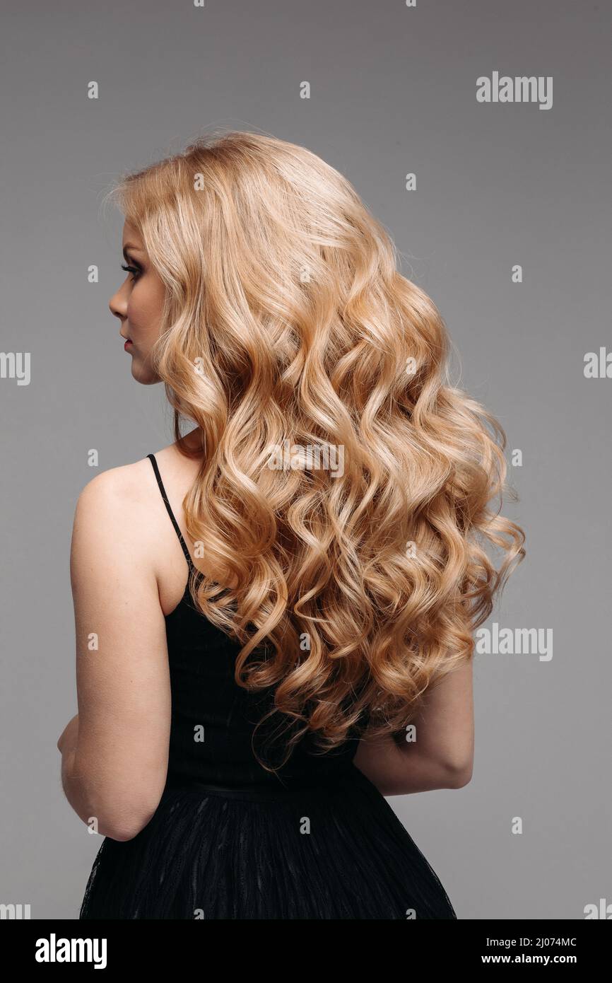 Stunning woman with perfect wavy blonde hair Stock Photo - Alamy