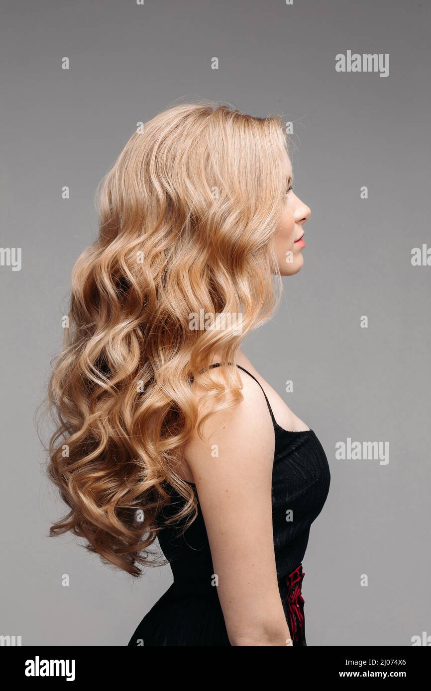 Stunning woman with perfect wavy blonde hair Stock Photo - Alamy