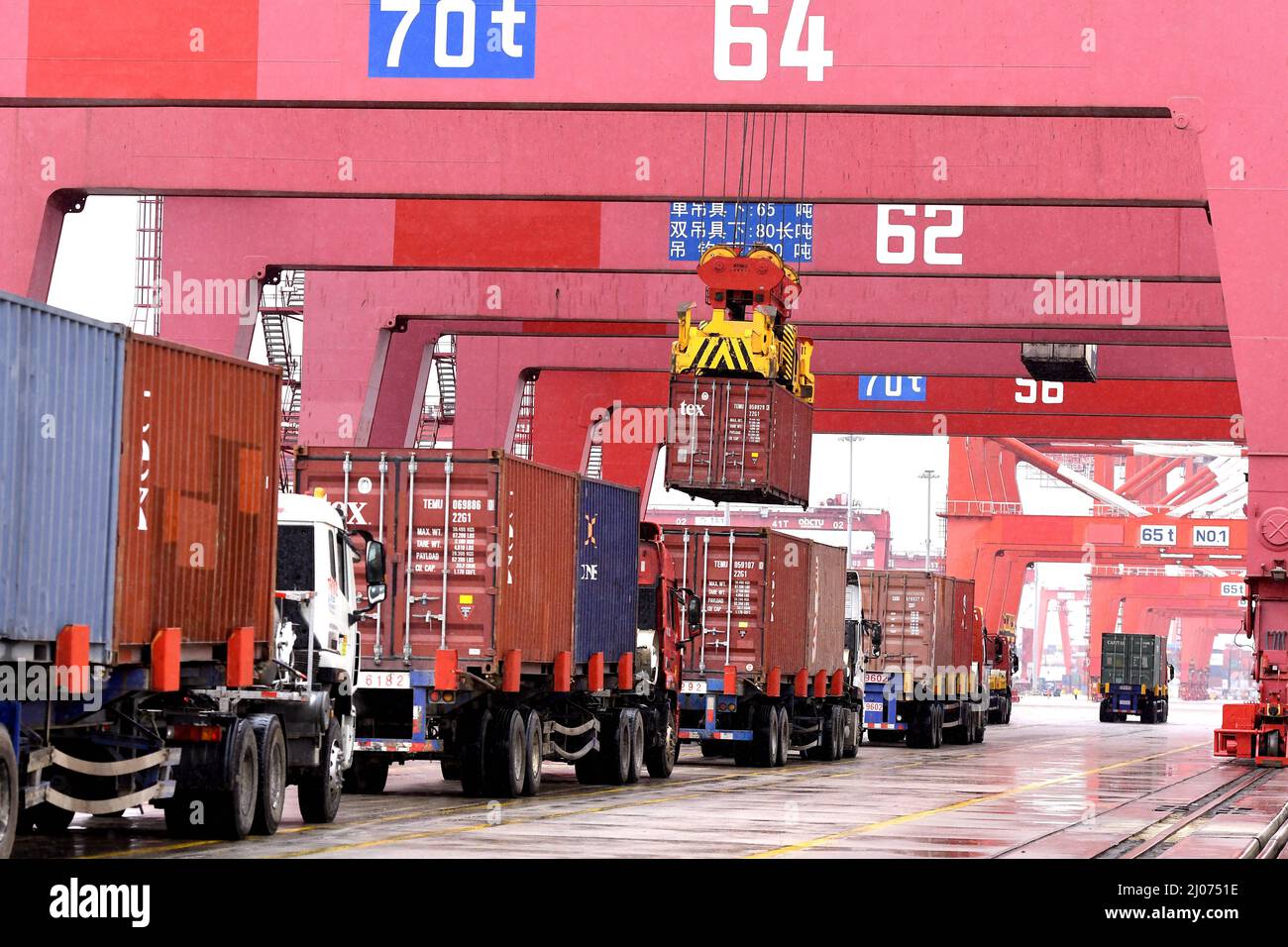 QINGDAO, CHINA - MARCH 17, 2022 - Cargo ships load and unload ...