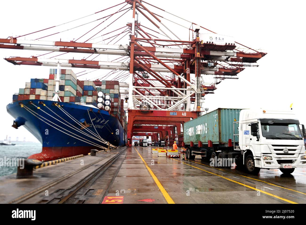 QINGDAO, CHINA - MARCH 17, 2022 - Cargo ships load and unload ...