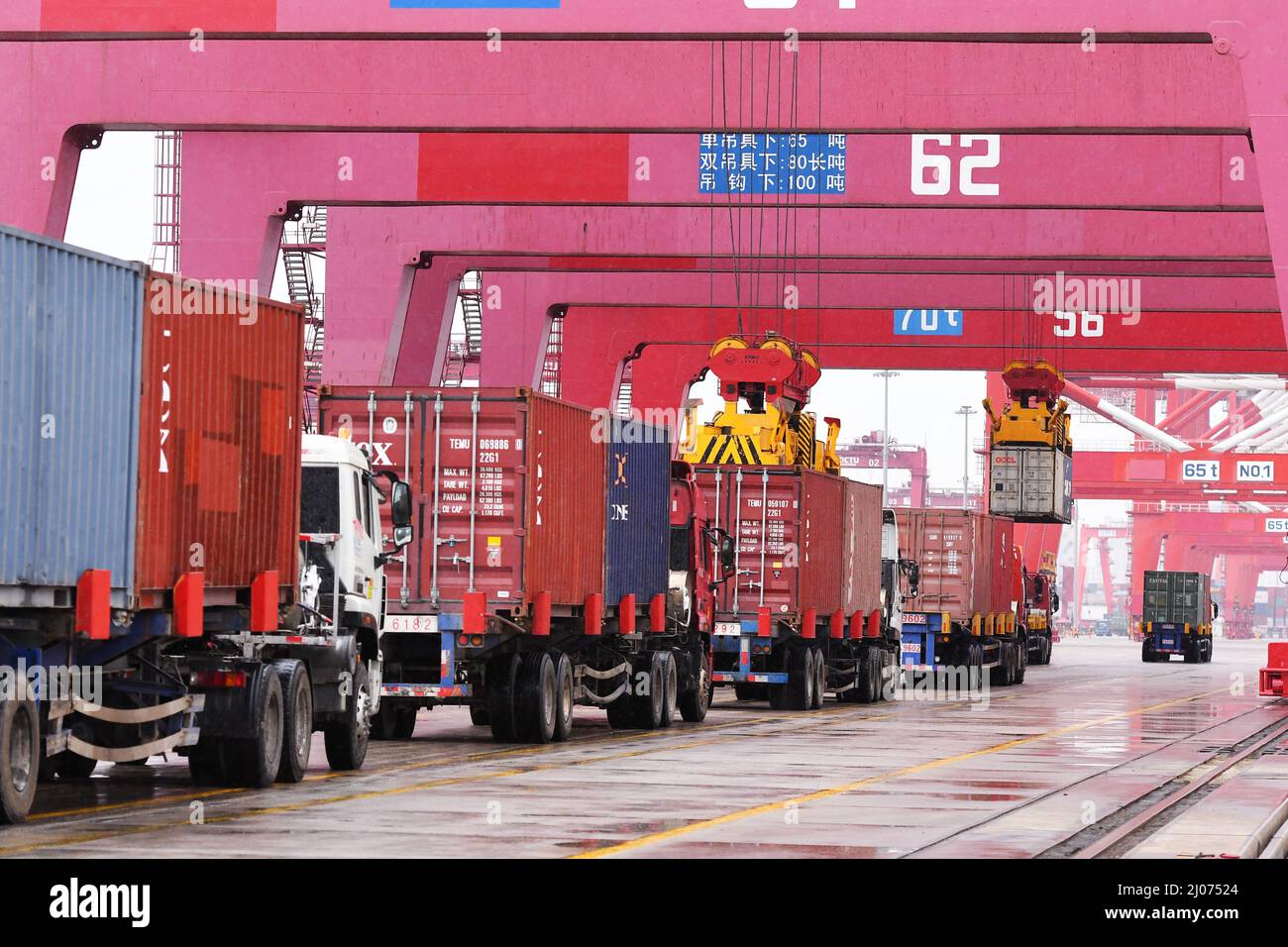 QINGDAO, CHINA - MARCH 17, 2022 - Cargo ships load and unload ...