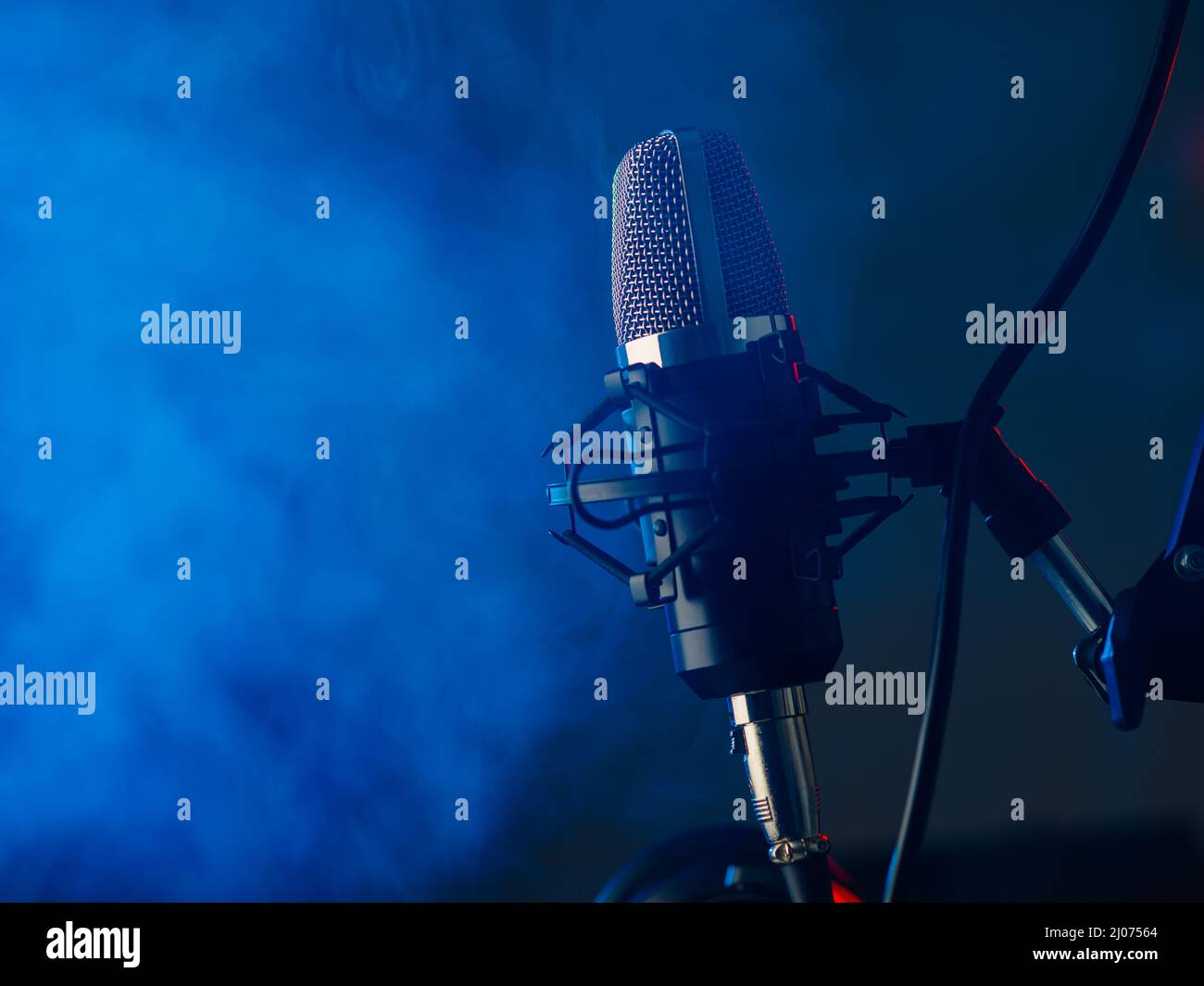 Studio microphone on blue smoke background. Vocal, blogger and sound ...