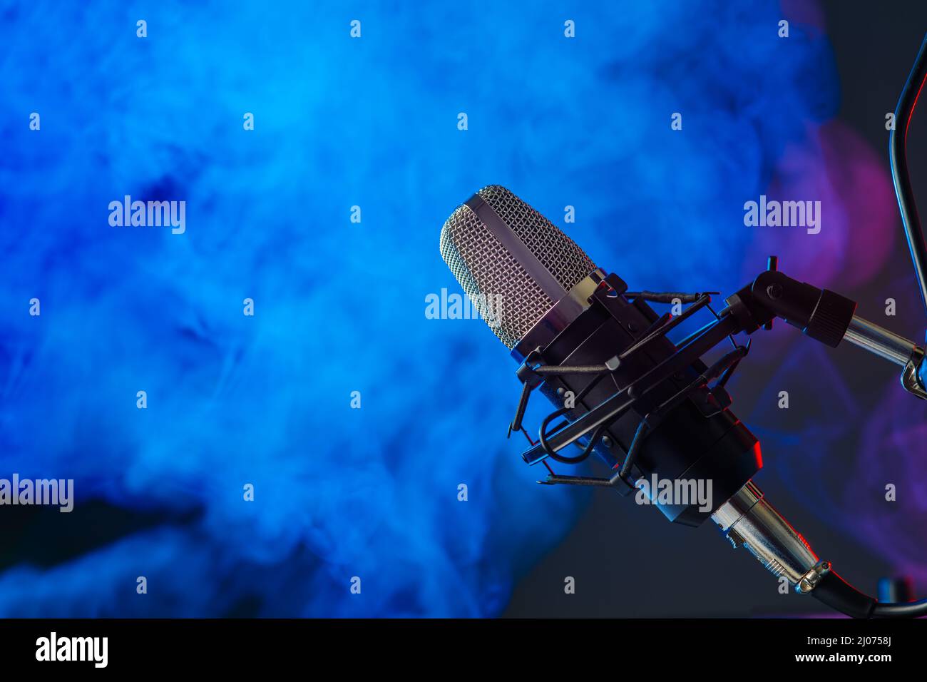 Studio microphone on blue smoke background. Vocal, blogger and sound ...