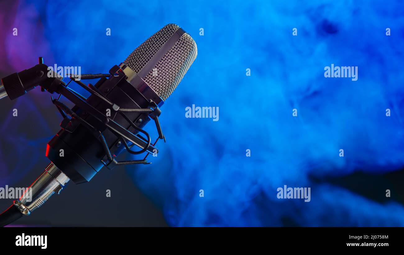 Studio microphone on blue smoke background. Vocal, blogger and sound ...