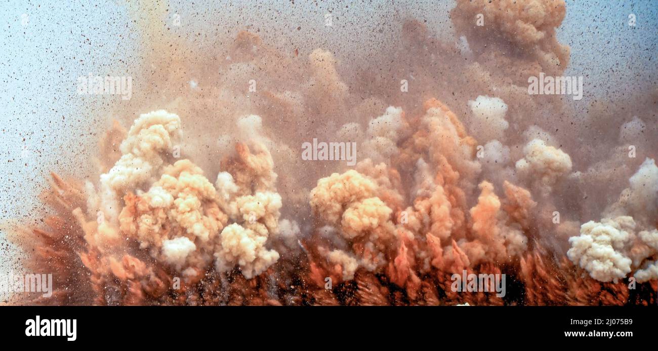 Flying rock and dust clouds after detonator blast in the desert Stock ...