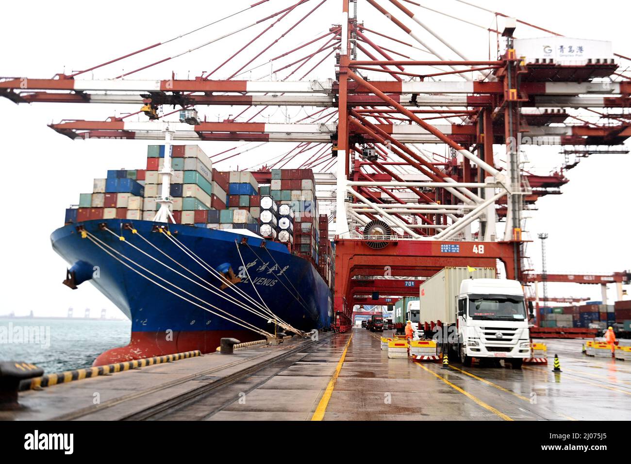 QINGDAO, CHINA - MARCH 17, 2022 - Cargo ships load and unload ...