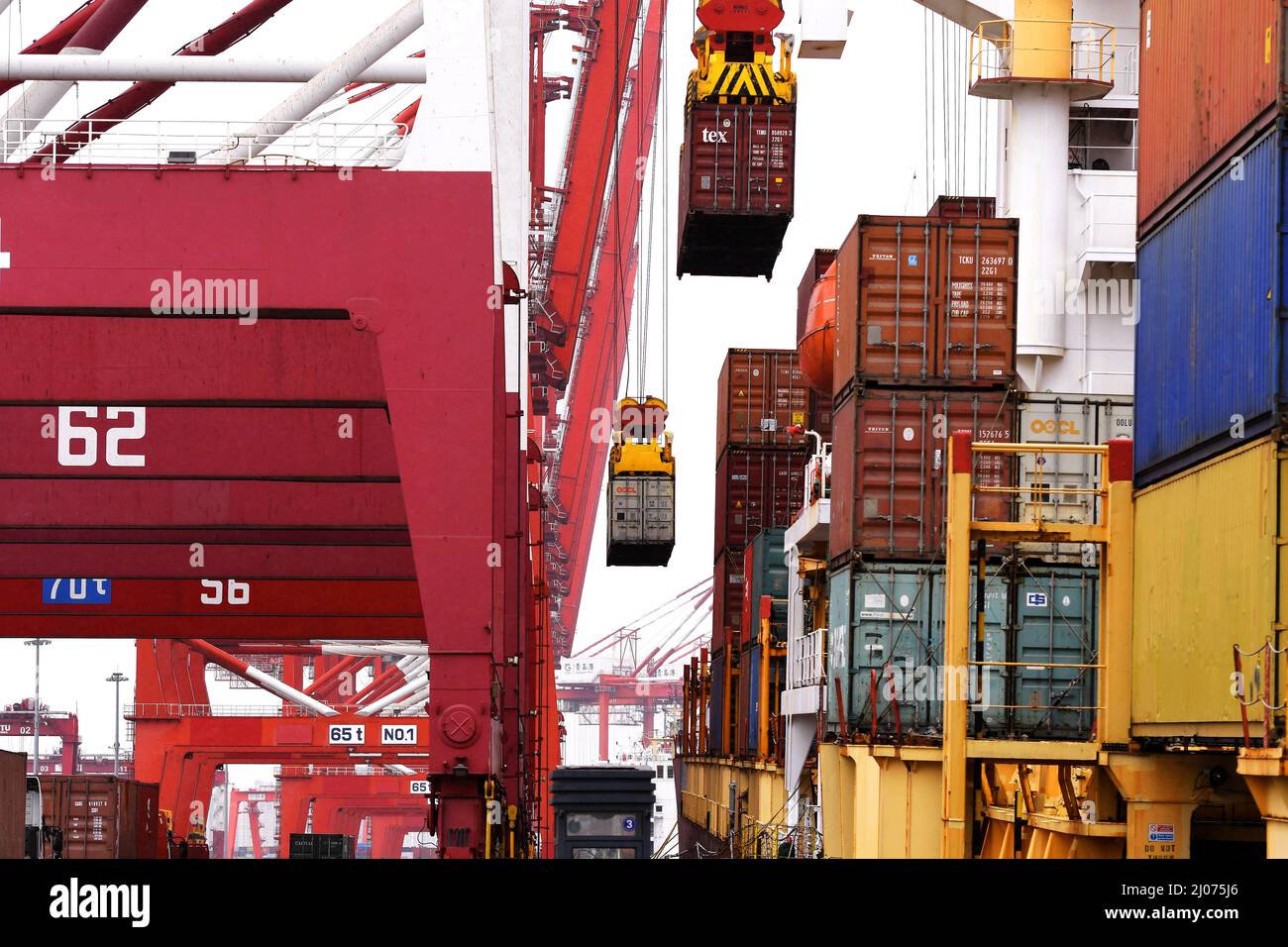 QINGDAO, CHINA - MARCH 17, 2022 - Cargo ships load and unload ...