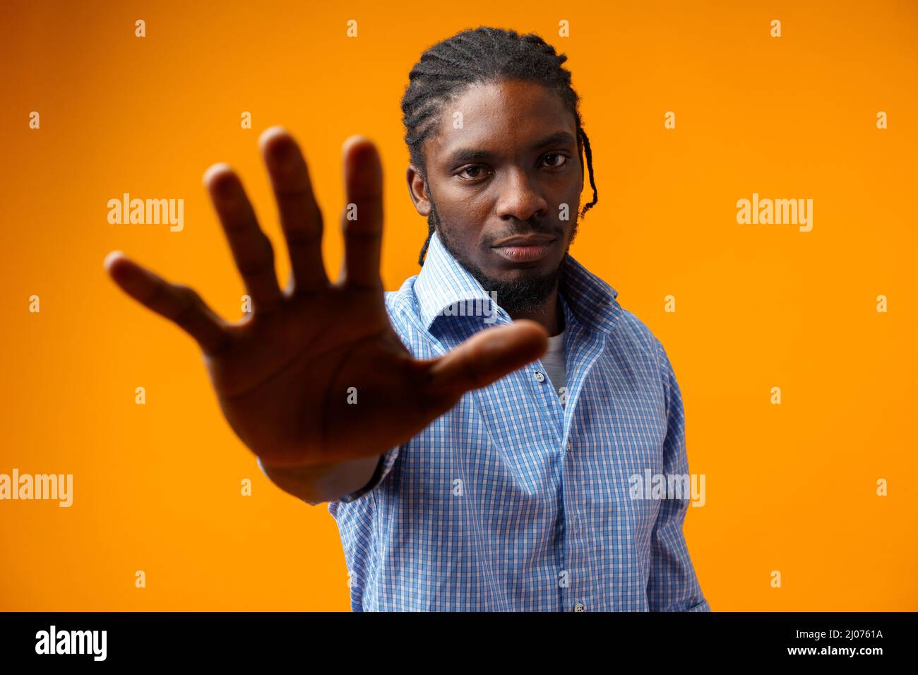Portrait of serious African American male showing hand stop sign Stock ...