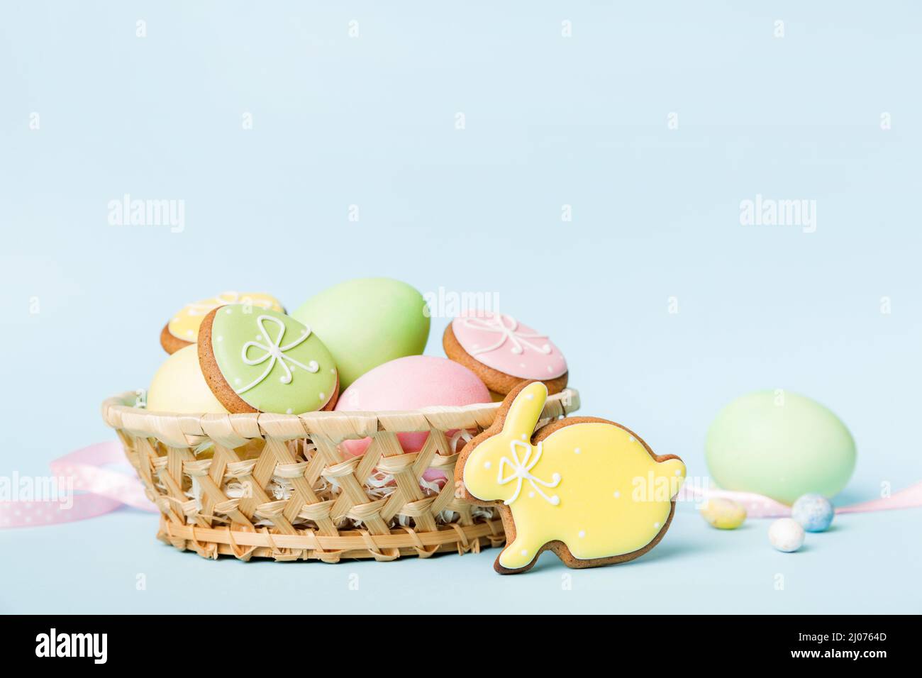 Colorful easter cookies in basket with Multi colors Easter eggs on ...