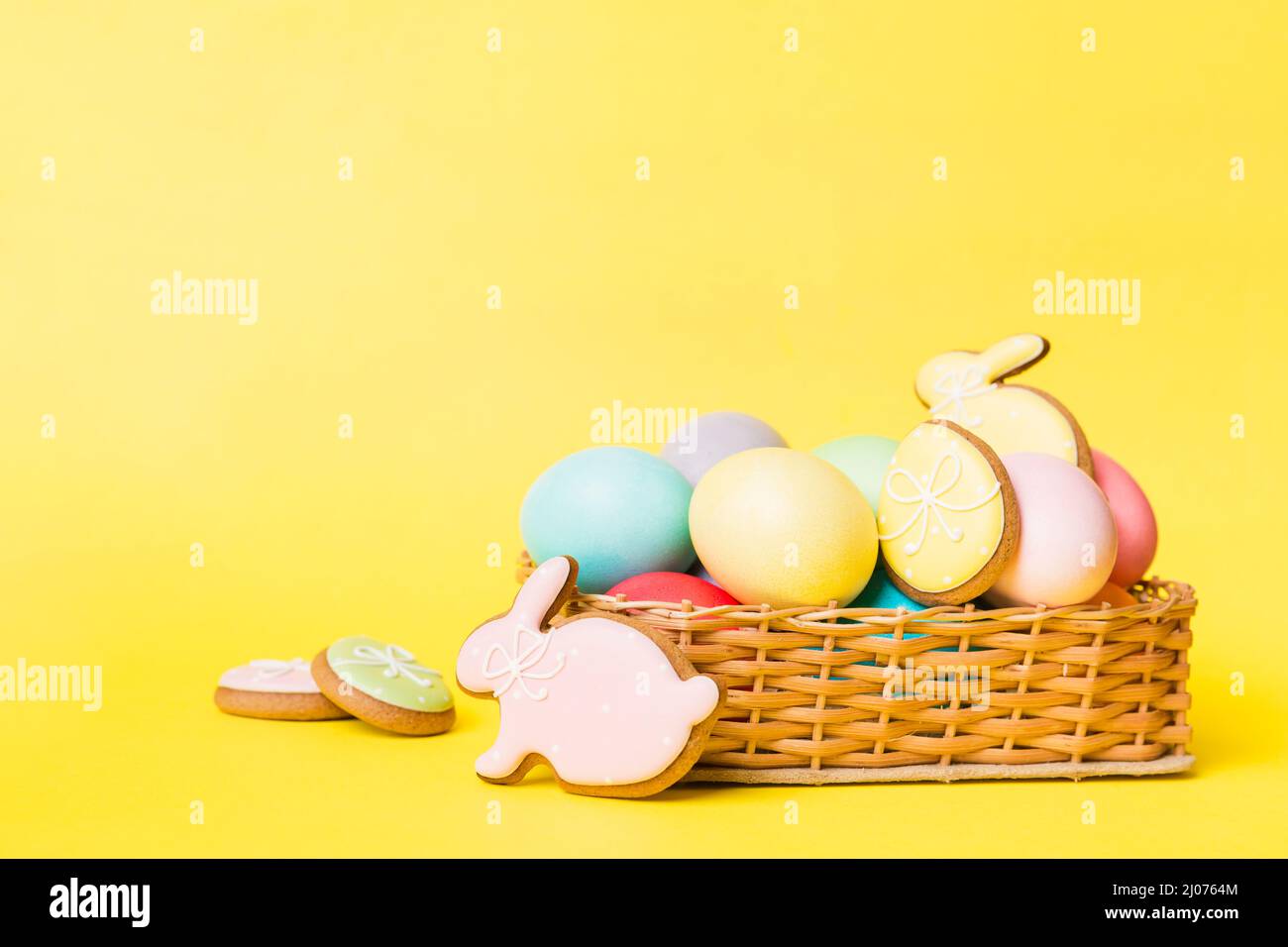 Colorful easter cookies in basket with Multi colors Easter eggs on ...