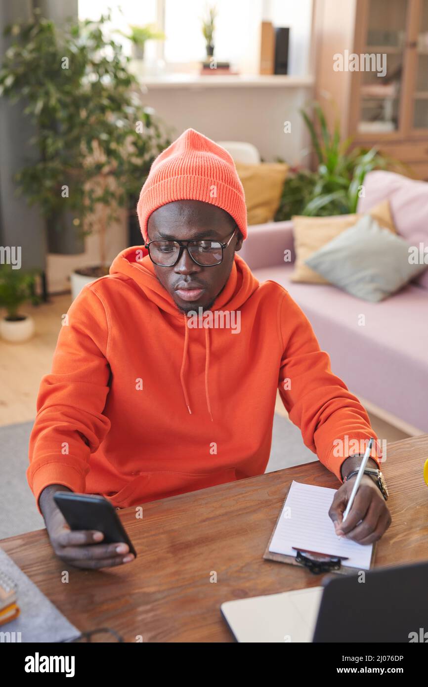 Vertical high angle of young African American college student sitting ...