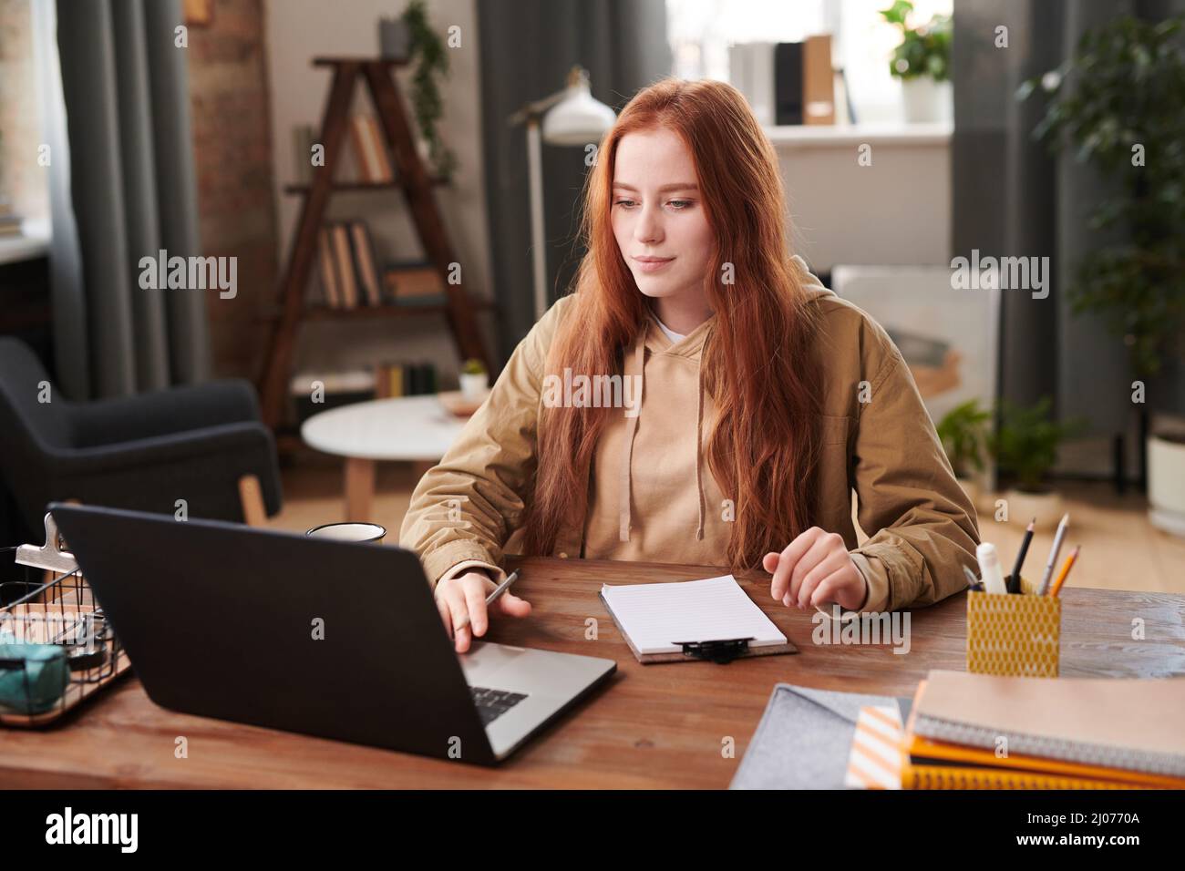 Horizontal medium portrait of female university student with long red ...