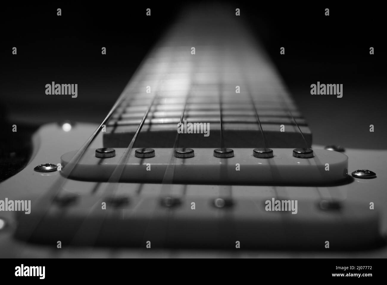 Grayscale closeup of the guitar strings on dark background Stock Photo ...