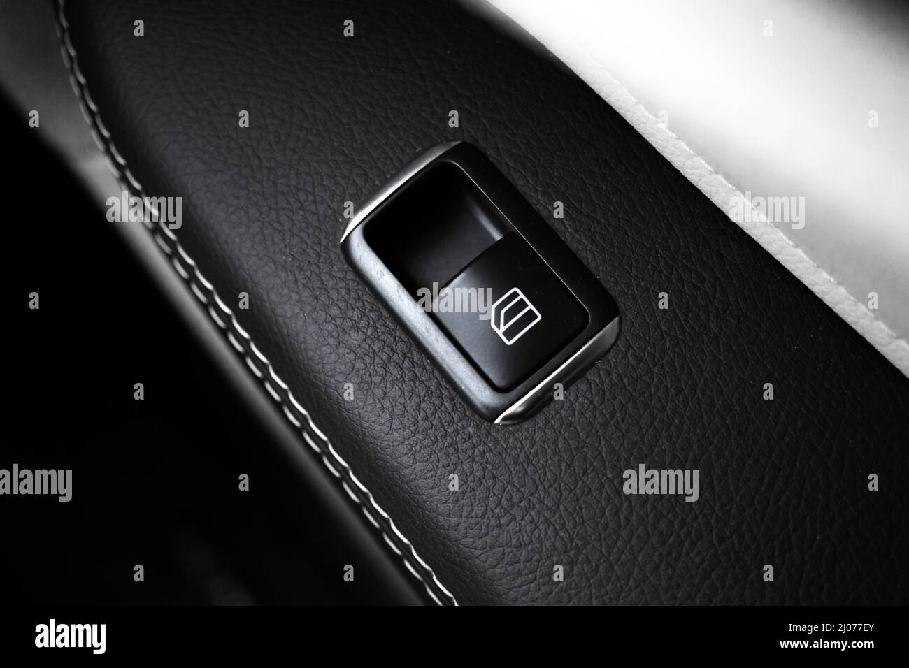 Window button inside luxury car with leather interior. Automatic power ...