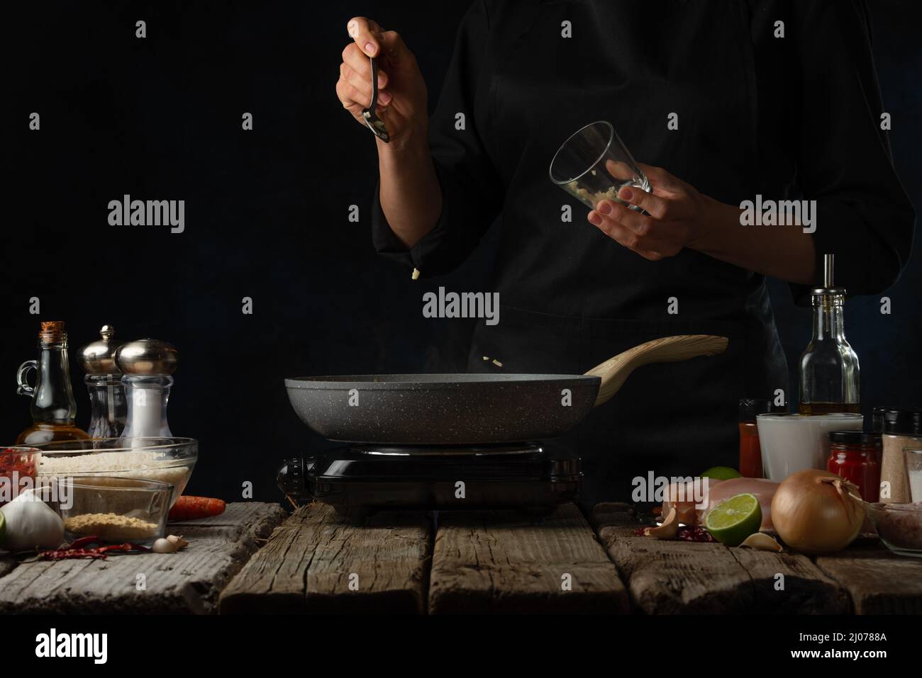 Professional chef pours garlic hi-res stock photography and images - Alamy