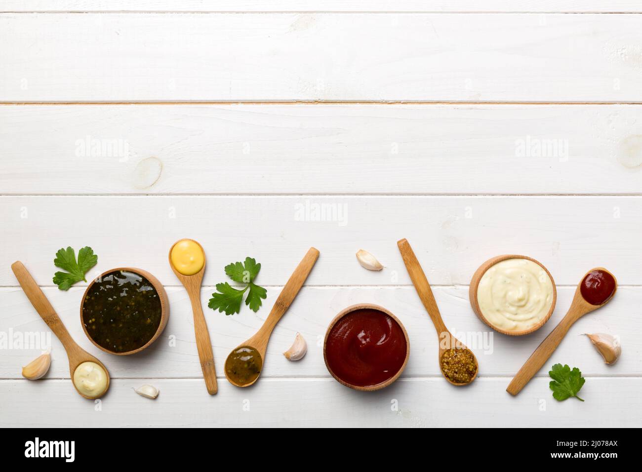 Different sauces in spoons on table background, flat lay top view Stock ...