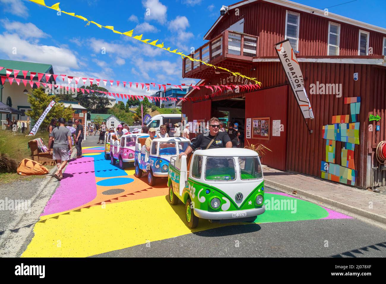 Children riding on a "Kombi Ride", a miniature train made to look like ...