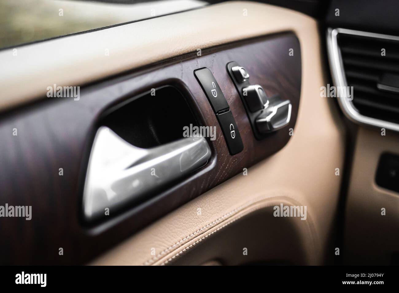 Car door handle and lock switch inside luxury and modern vehicle with ...