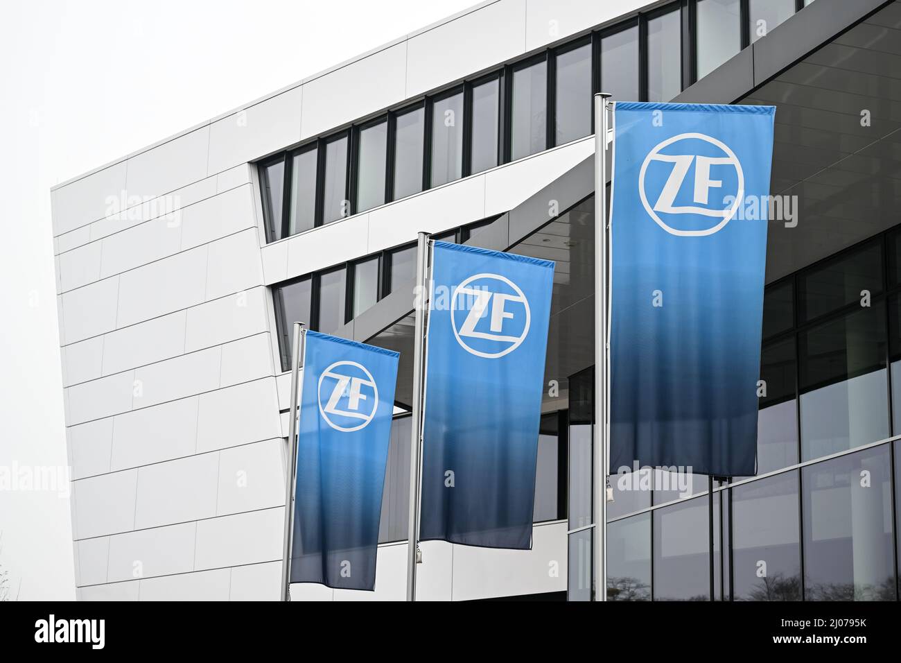 Friedrichshafen, Germany. 17th Mar, 2022. Three flags with the ZF ...