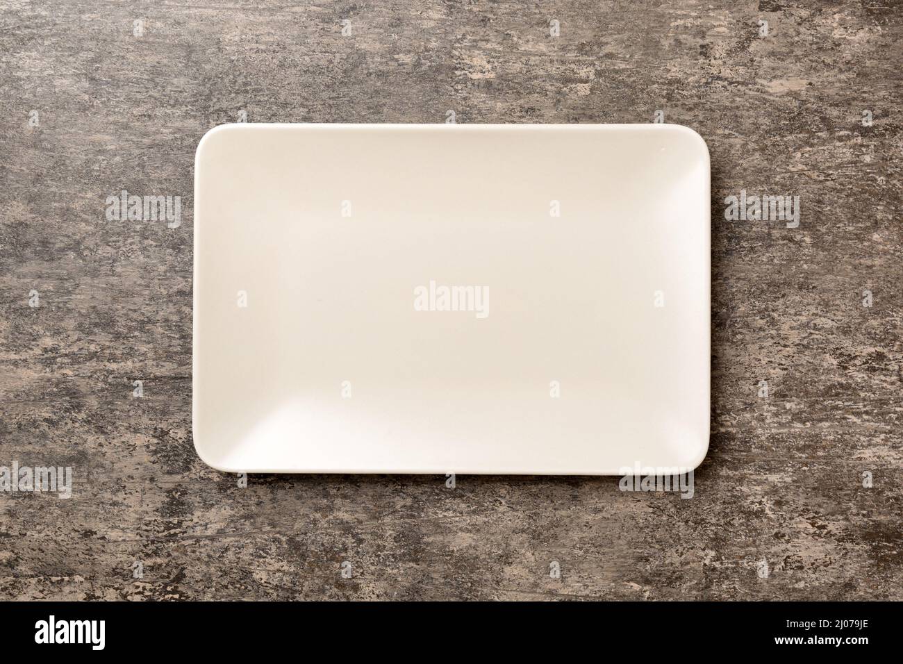 Top view of empty square plate on cement background. Empty space for ...