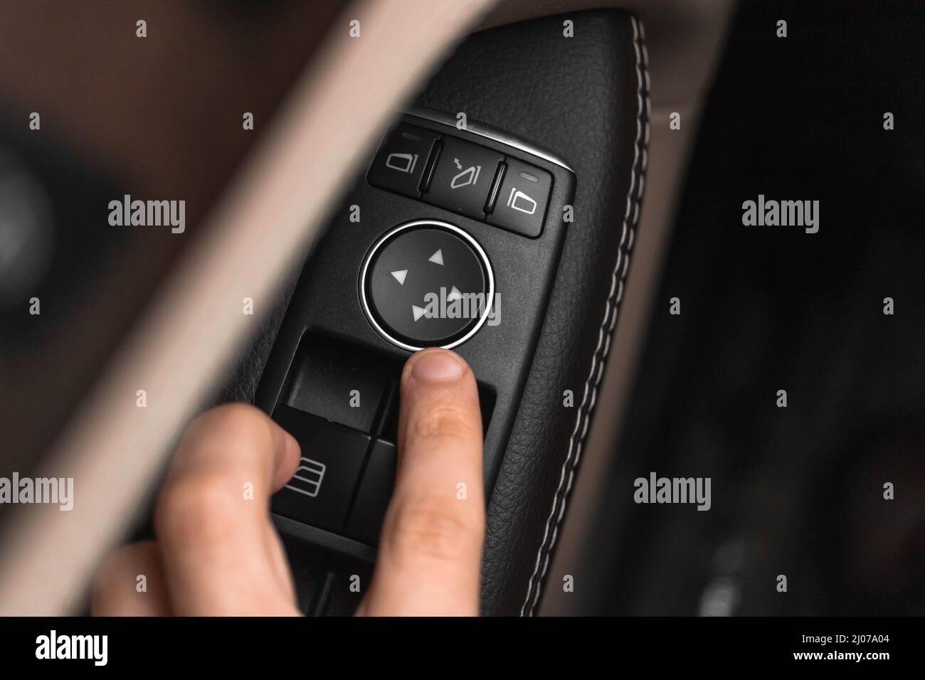 Close-up hand pressing button automatic power controlling window in car ...