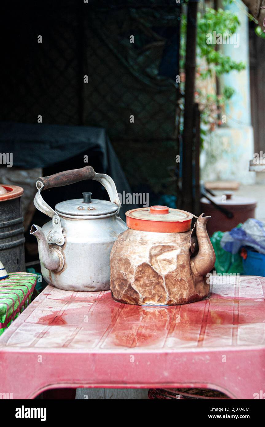 Old dented tea kettles in Vietnam Stock Photo - Alamy