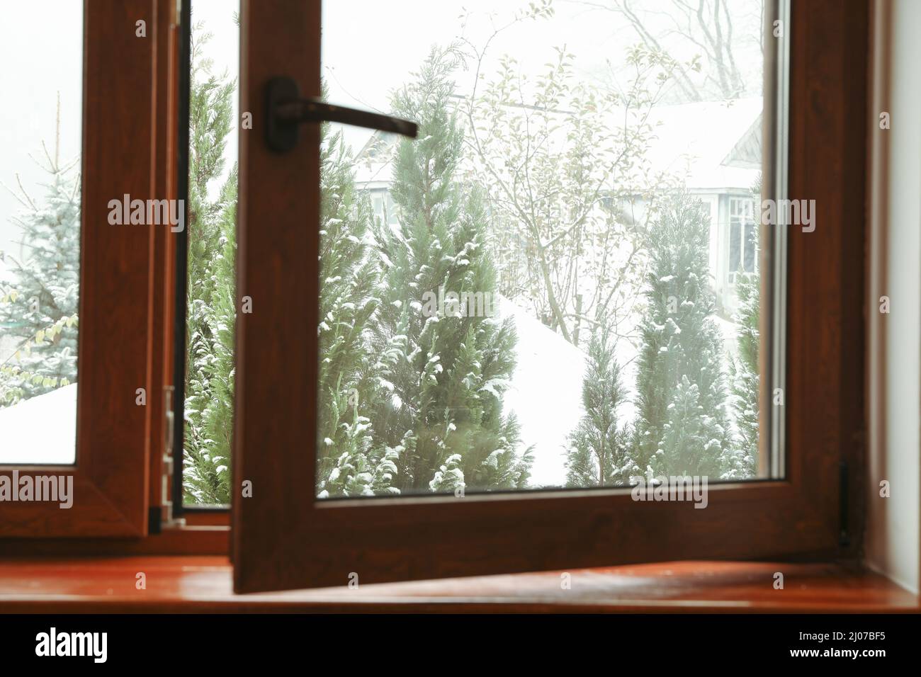 Open window with view on snowy day Stock Photo - Alamy